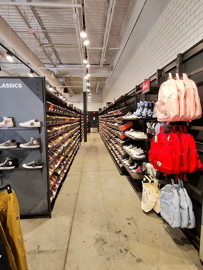 The Converse store's sneaker wall stretches into infinity, a cathedral of casual footwear where Chuck Taylor disciples find their soles.