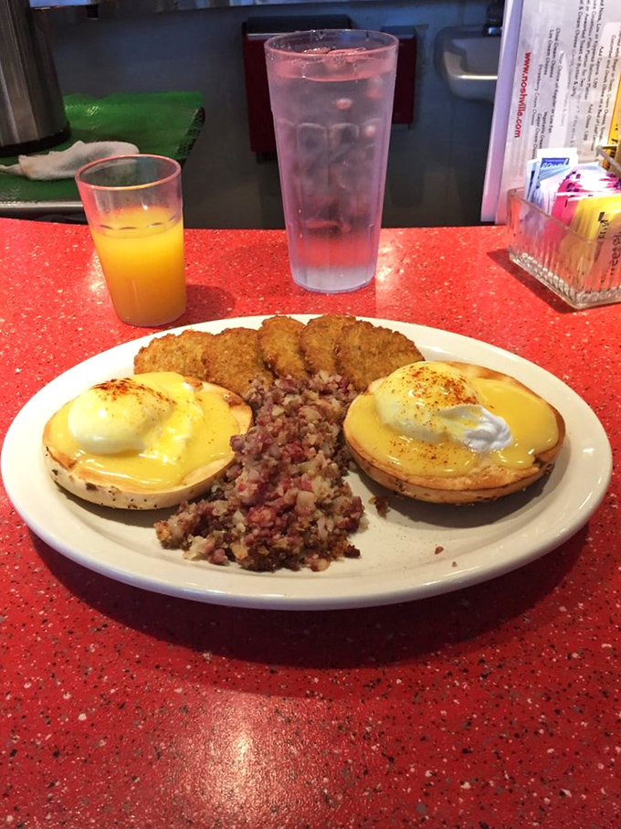 Eggs Benedict with a side of corned beef hash—proof that breakfast can be both elegant and hearty simultaneously. The hollandaise speaks volumes.