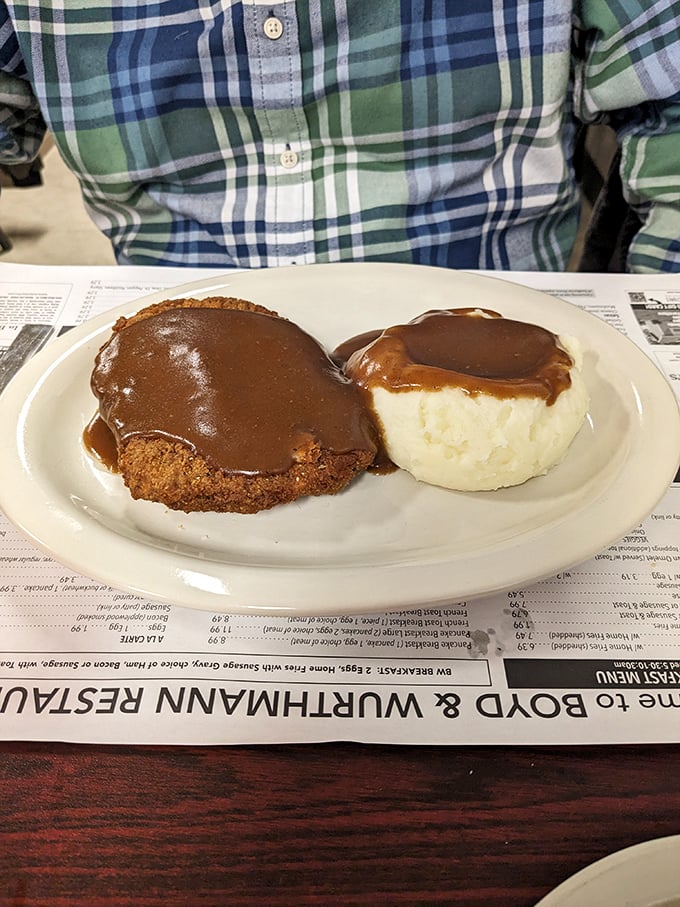 Country fried steak swimming in gravy alongside cloud-like mashed potatoes. This isn't a meal; it's a warm hug from your grandmother.