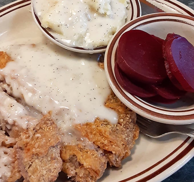 Country fried steak swimming in creamy gravy with pickled beets on the side—comfort food that hugs your insides like a warm Pennsylvania blanket.