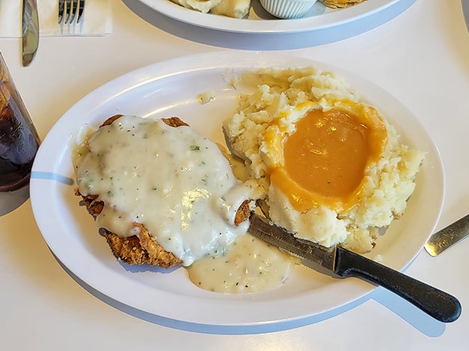 Country fried steak swimming in gravy – because sometimes your arteries deserve a vacation too.