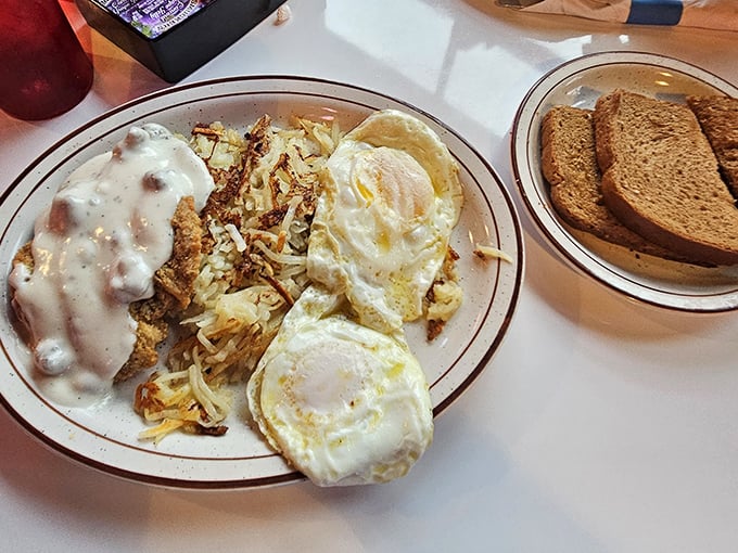 Breakfast served with a side of nostalgia—eggs sunny-side up, crispy hash browns, and country gravy that would make your grandmother nod in approval.