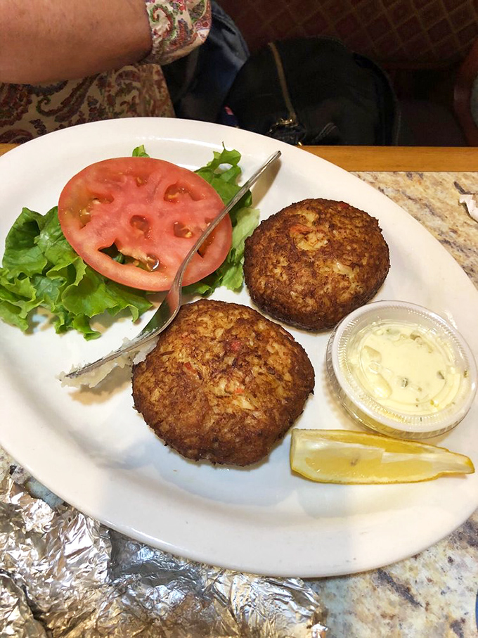 Golden-brown crab cakes that don't hide behind fillers—just pure, sweet crabmeat with a crispy exterior that shatters with each bite.