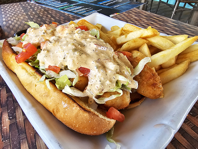 This isn't just a sandwich; it's an edible postcard from paradise – fried seafood, crisp veggies, and remoulade sauce on a pillowy roll.