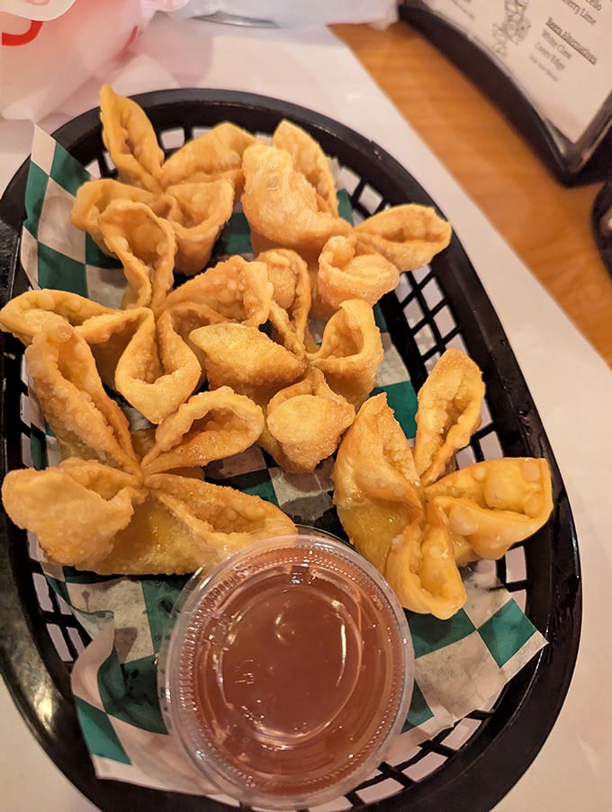 Golden-fried crab rangoons with that perfect crunch-to-cream ratio—the kind that makes you wonder why you'd ever share an order.