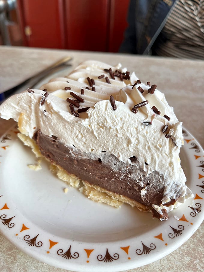 Chocolate cream pie with a cloud of whipped topping and chocolate sprinkles—proof that heaven exists on earth.