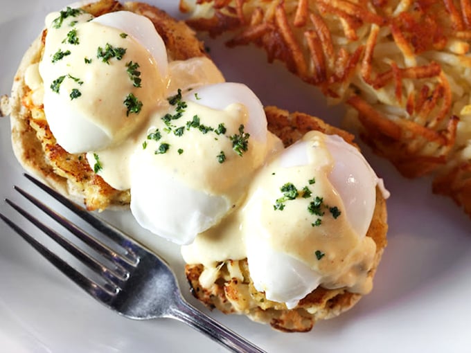 These Eggs Benedict aren't just breakfast, they're performance art – perfectly poached eggs perched atop crispy crab cakes like synchronized swimmers in hollandaise.