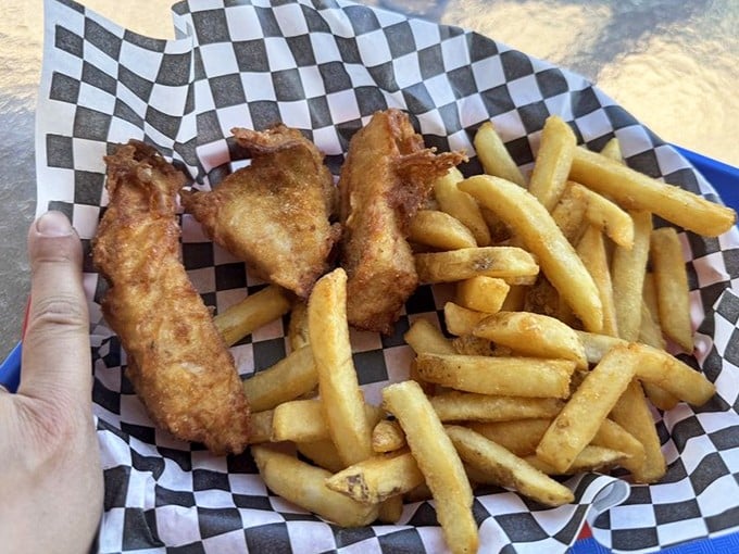 Golden, crispy fish and chips served in checkered paper—comfort food that understands its assignment perfectly.