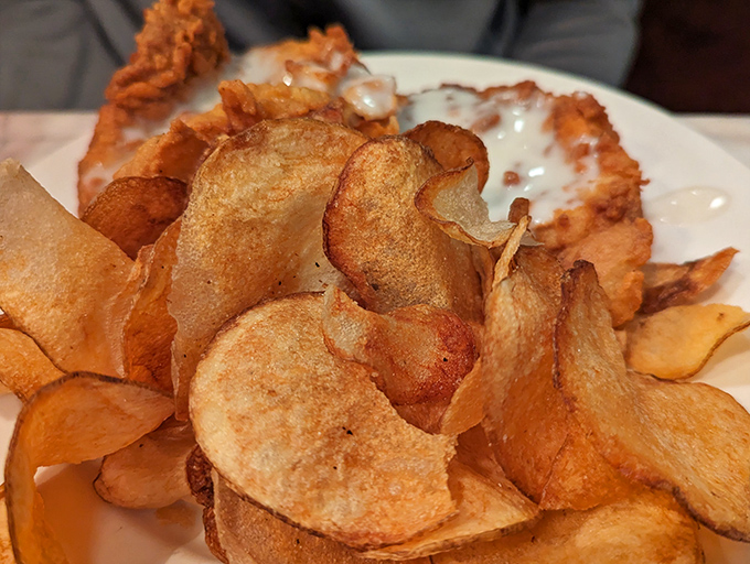 These aren't just potato chips—they're edible postcards from potato heaven, golden-brown and crispy enough to make you forget your table manners.