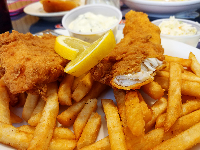 Golden-battered fish with perfectly crisp fries—the kind of plate that makes you forget about your diet faster than you can say "tartar sauce, please."