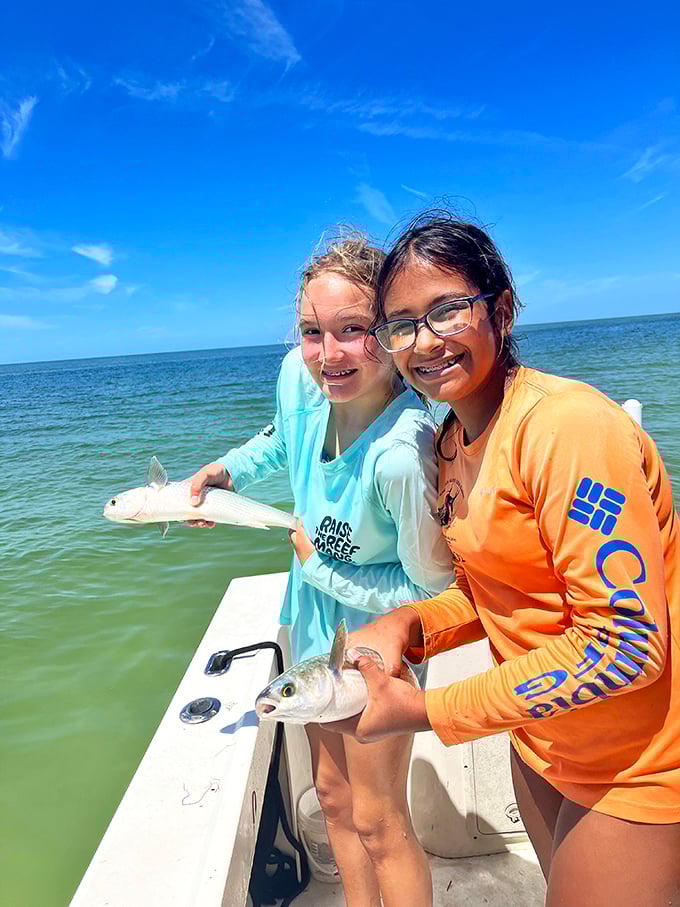 The universal joy of fishing knows no age limits. These young anglers proudly display their catch – memories being made one fish at a time.