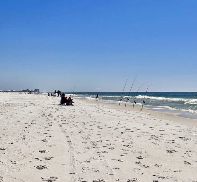 The patient fisherman's reward: uninterrupted horizon and possibility. Poles standing at attention like eager soldiers awaiting orders from the sea.