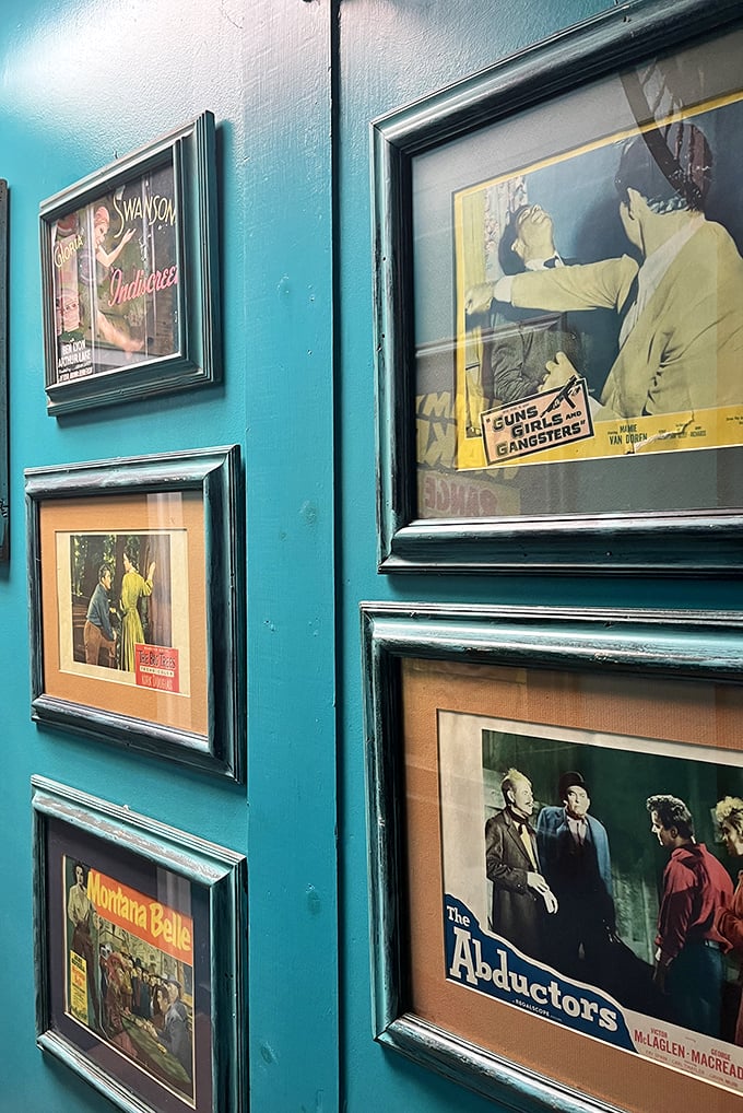 A teal wall gallery of vintage movie memorabilia – where Gloria Swanson and gangster flicks become conversation starters in your home.