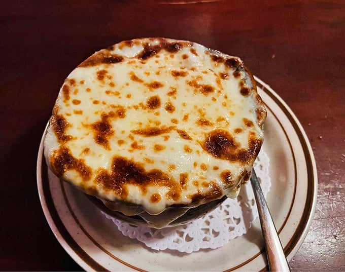 French onion soup that's wearing its cheese like a crown – bubbling, golden, and worthy of royal treatment from your spoon.