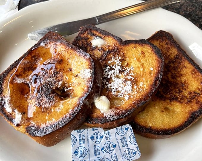 French toast that's achieved the impossible: perfectly crisp edges while maintaining that custardy center. Maple syrup application pending.