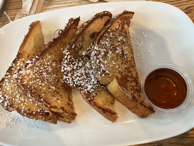 French toast that doesn't just participate in breakfast—it throws a parade. Dusted with powdered sugar and served with amber syrup for dunking perfection.