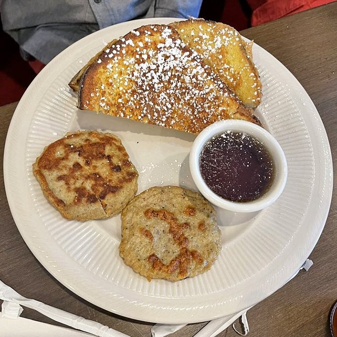 French toast that's achieved the perfect golden hue, dusted with powdered sugar like the first perfect snowfall of winter—Michigan breakfast poetry on a plate.