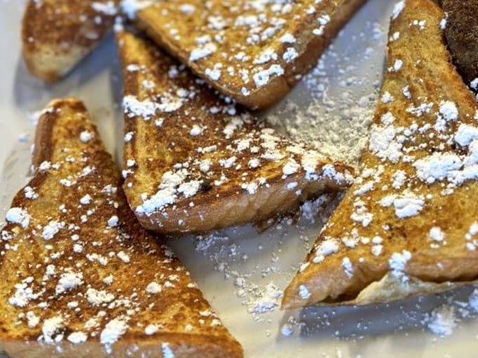 French toast dusted with powdered sugar like the first snow of winter – simple perfection that doesn't need Instagram filters to impress.