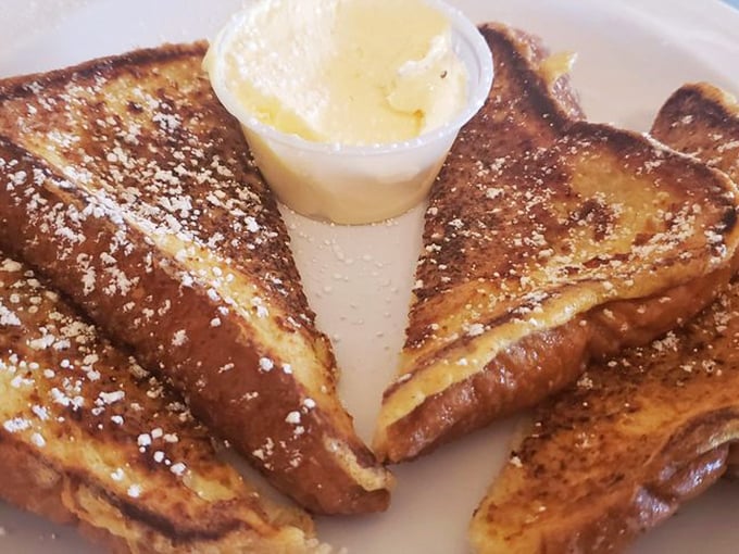 French toast that's achieved that mythical balance – crispy exterior, custardy interior, and enough powdered sugar to make your dentist wince with delight.