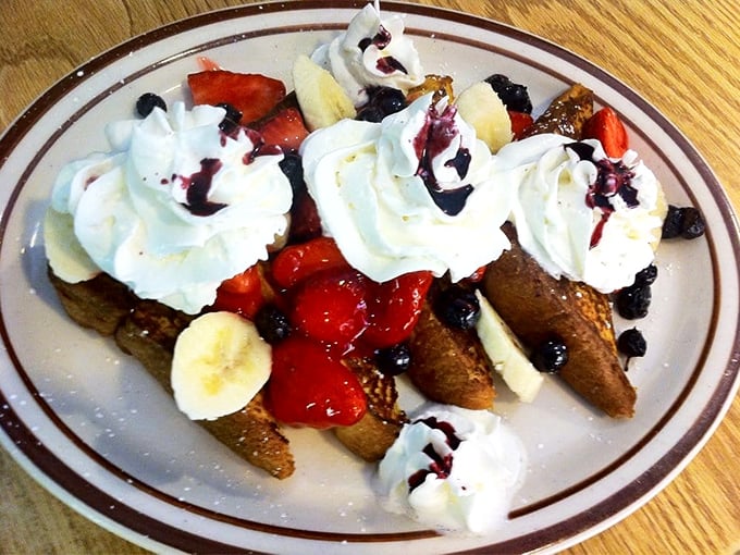 French toast that doesn't just break the fast—it celebrates it. Topped with fresh fruit, whipped cream, and berry sauce, it's breakfast masquerading as dessert.
