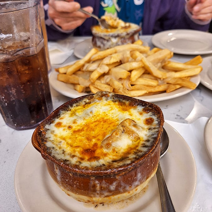 French onion soup that's worth the cheese pull. That molten layer of broiled cheese hiding savory broth beneath is the winter hug we all need.