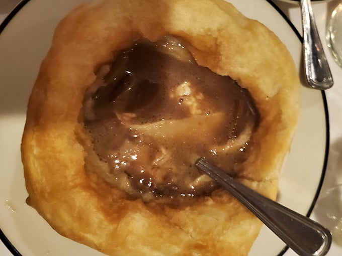 French onion soup bubbling under a golden cheese blanket—comfort food that knows exactly what it's doing here.