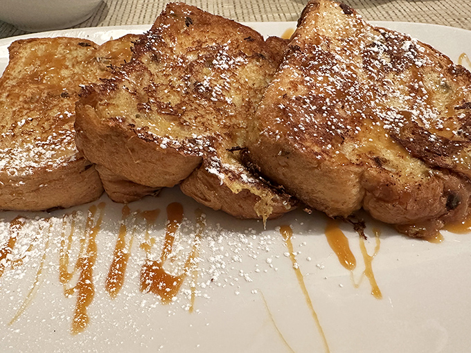 French toast that makes you question why anyone would ever settle for regular toast—caramelized to perfection and dusted with powdered sugar snow.