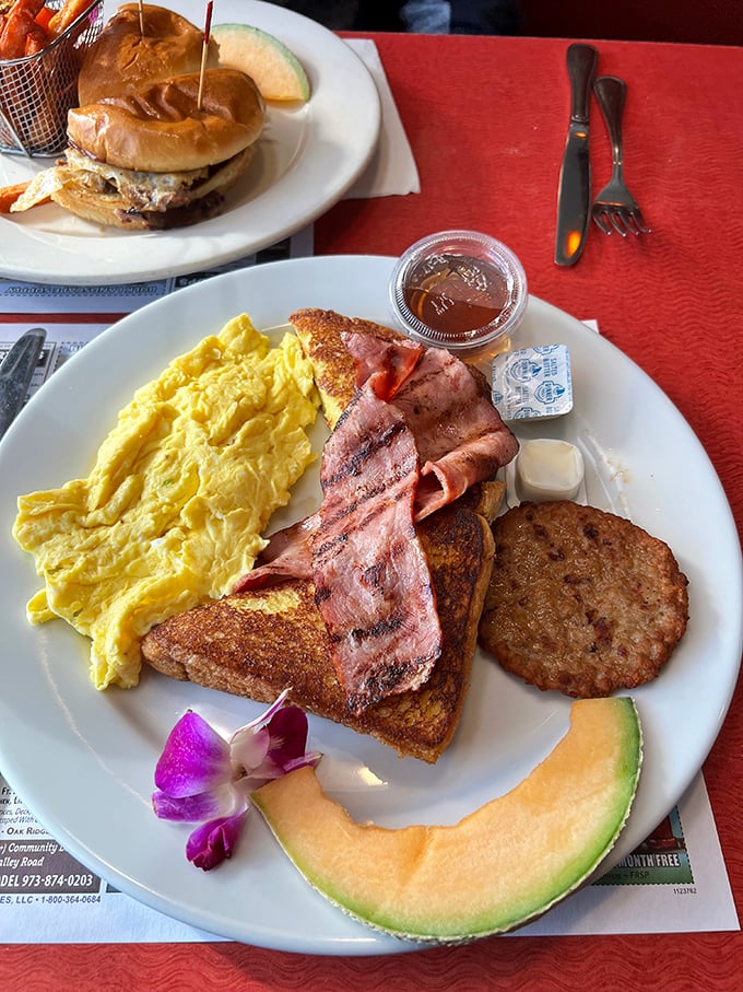 This breakfast platter doesn't just break the fast—it demolishes it with perfect eggs, toast, and that slice of cantaloupe pretending to be healthy.