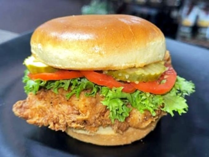This fried chicken sandwich isn't just a meal, it's an event – crispy, juicy, and dressed to impress with fresh veggies standing at attention.