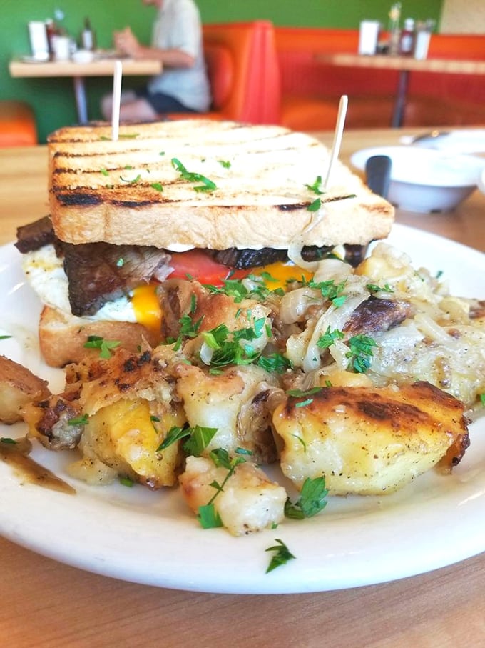 This isn't just breakfast—it's edible architecture. Crispy potatoes, melted cheese, and a sandwich that demands both hands and your full attention.