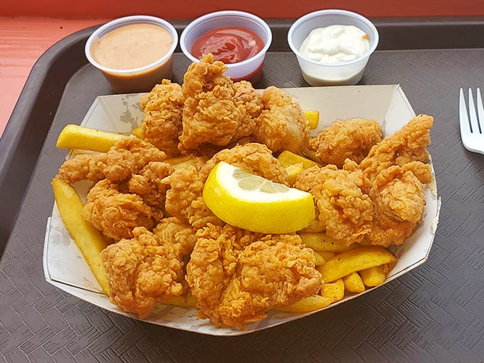 Crispy nuggets of fried goodness that would make even the Colonel jealous, served with a lemon wedge that's not just garnish—it's essential.