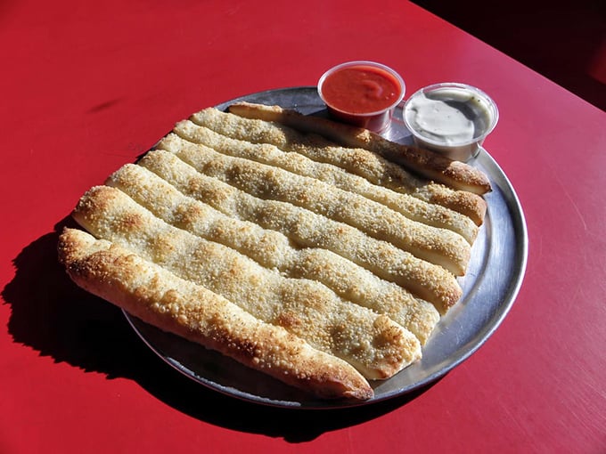 Garlic breadsticks that strike the perfect balance between crisp exterior and pillowy interior—the kind worth driving across state lines for.