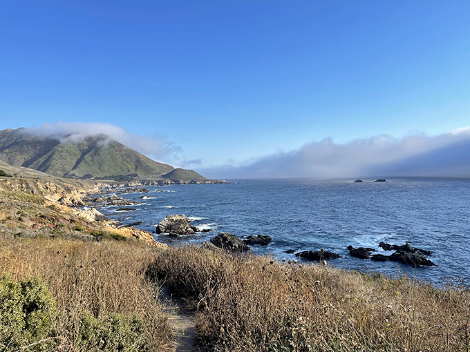 The morning fog playing peekaboo with the mountains at Garrapata State Park—nature's own smoke machine creating drama for free.