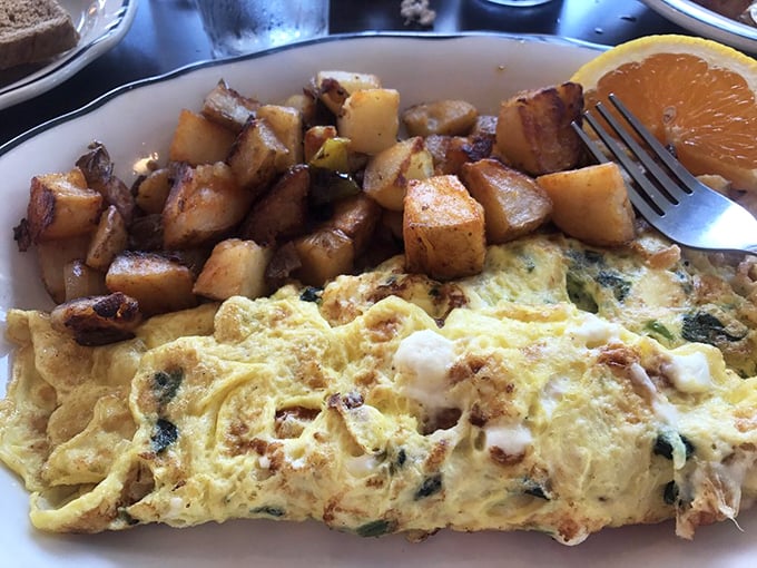 This isn't just breakfast, it's morning therapy—a Greek omelet with home fries that could solve most of life's problems.