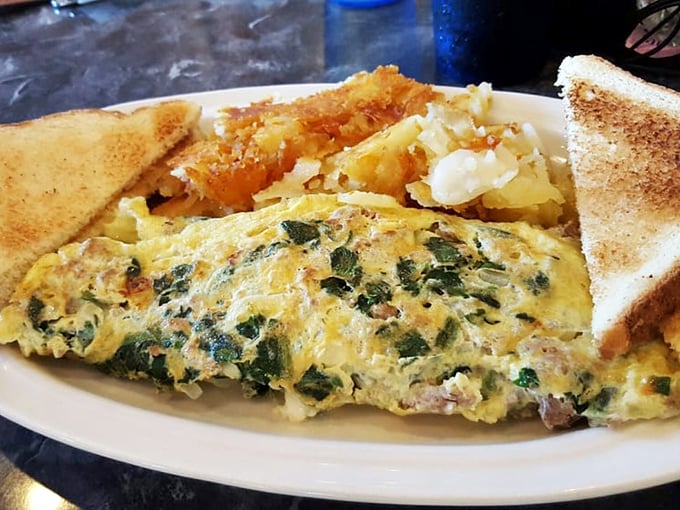 An omelet that doesn't just contain vegetables—it celebrates them. Paired with golden home fries that crackle with each bite.