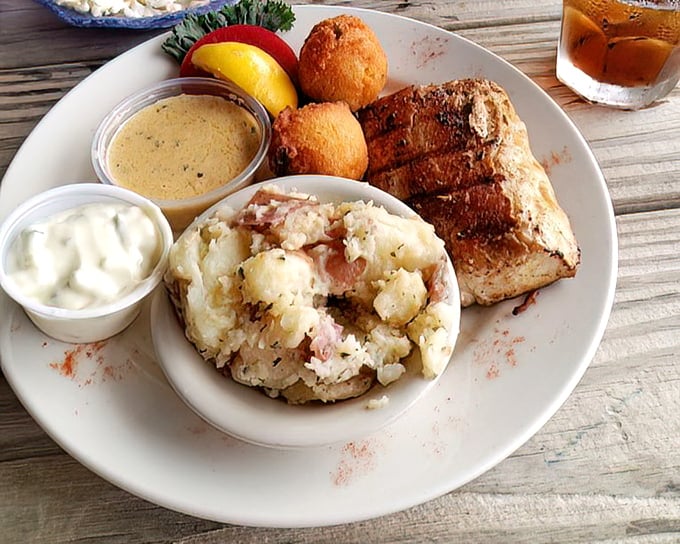 This isn't just grilled fish – it's a love letter to the sea. Perfectly seared mahi-mahi with potato salad and hush puppies makes for coastal poetry.