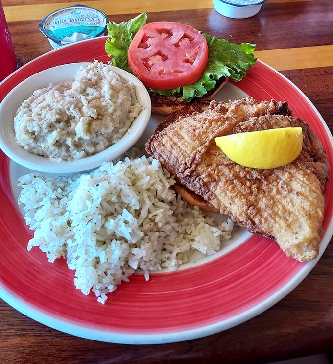 This grouper sandwich isn't just lunch—it's Florida on a bun, with rice and grits playing perfect supporting roles.