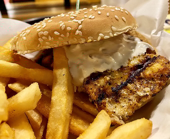 This fish sandwich doesn't need ocean views to transport you to paradise – just golden-fried perfection, crisp fries, and a sesame bun throne.