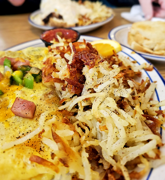 This isn't just breakfast – it's edible architecture. Crispy hash browns supporting a perfectly cooked omelet, the foundation of a perfect morning.
