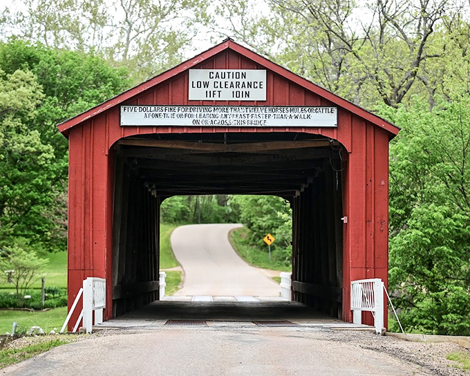 This red covered bridge isn't just picturesque – it's practically demanding you slow down and appreciate the craftsmanship of a bygone era.