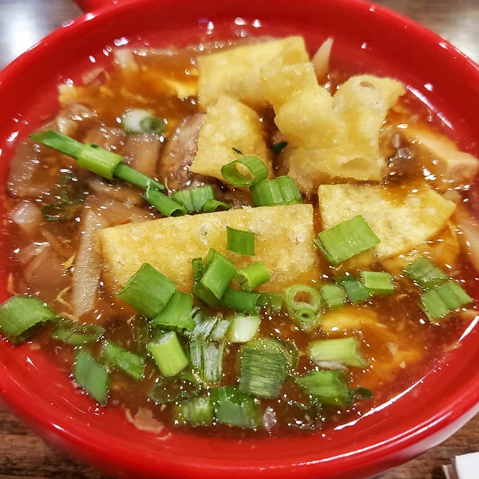 This hot and sour soup isn't just comfort in a bowl—it's a spicy, tangy symphony with crispy tofu islands and green onion confetti.