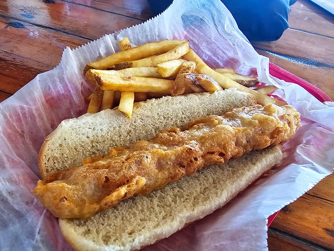 A battered hot dog that looks like it just won the lottery and decided to celebrate properly.