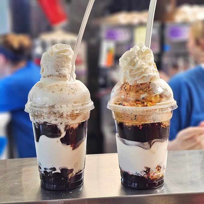 These parfait-style sundaes aren't just desserts—they're architectural marvels where chocolate, cream, and cookie crumbles create edible skyscrapers.