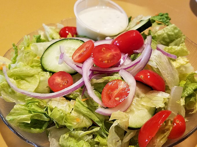 A garden on a plate! This salad isn't just the opening act—it's fresh enough to make you momentarily forget you came for pizza.