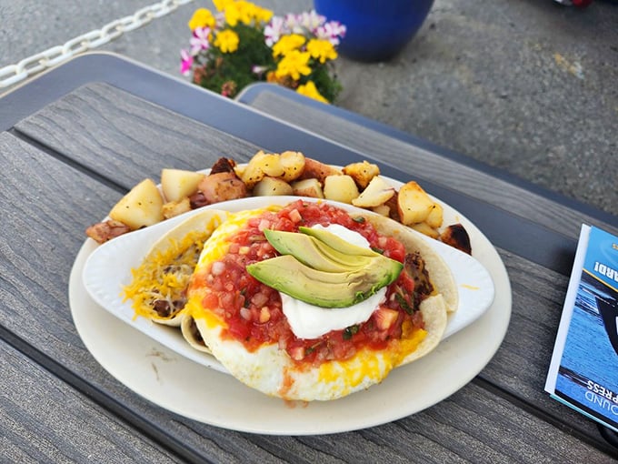 The Huevos Rancheros arrives like a fiesta on a plate – vibrant salsa, creamy avocado, and melted cheese creating the breakfast equivalent of a mariachi band.