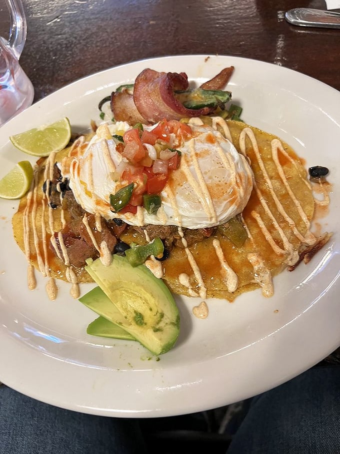 Not your abuela's huevos rancheros—this masterpiece comes dressed for success with avocado, fresh pico, and a drizzle that means business.