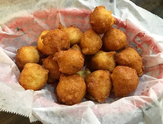 These hushpuppies aren't just side dishes – they're golden orbs of cornmeal perfection that might upstage the catfish if they weren't so humble about it.