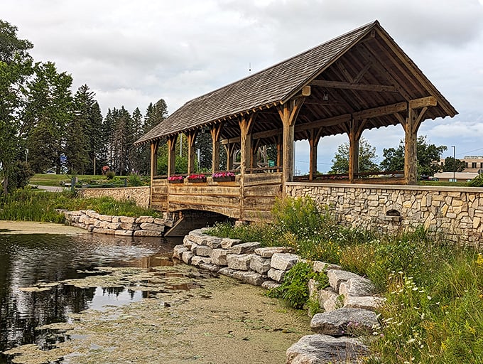 This rustic covered bridge at Island Park looks like it belongs on a postcard—or at minimum, your Instagram feed that makes friends jealous of your weekend escape.