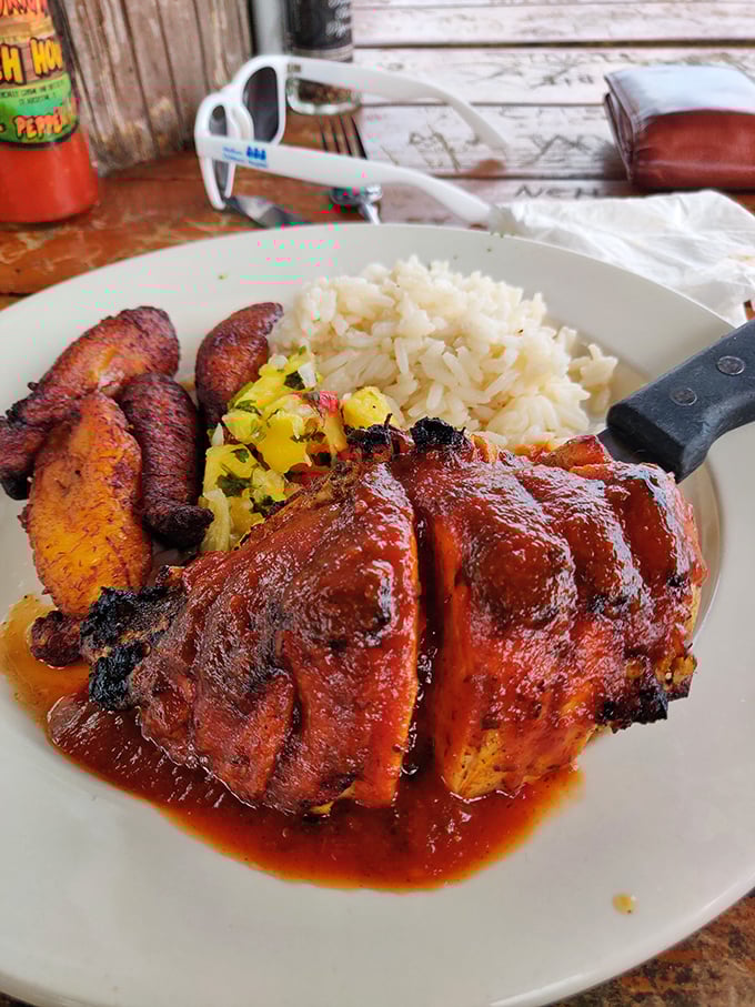 Jerk chicken with that perfect char, served with plantains and rice—proof that Caribbean flavors and Florida sunshine were made for each other.