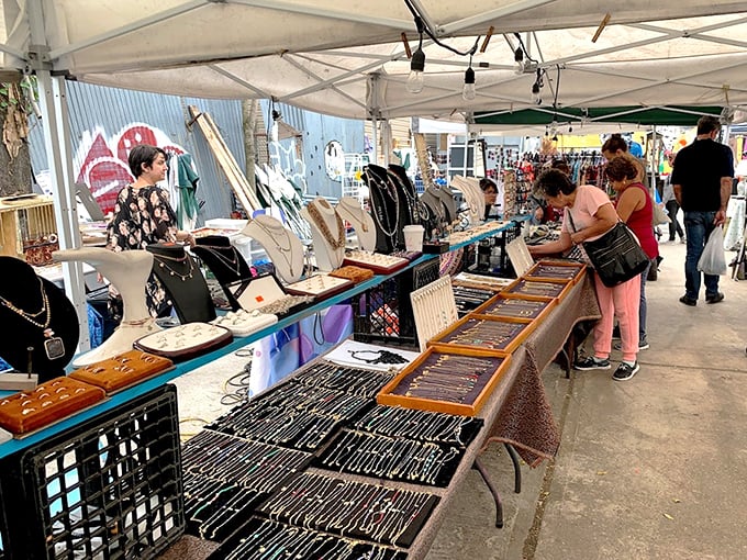 Jewelry hunters examine treasures with the focused intensity of archaeologists, each table a potential site for that perfect accessory discovery.